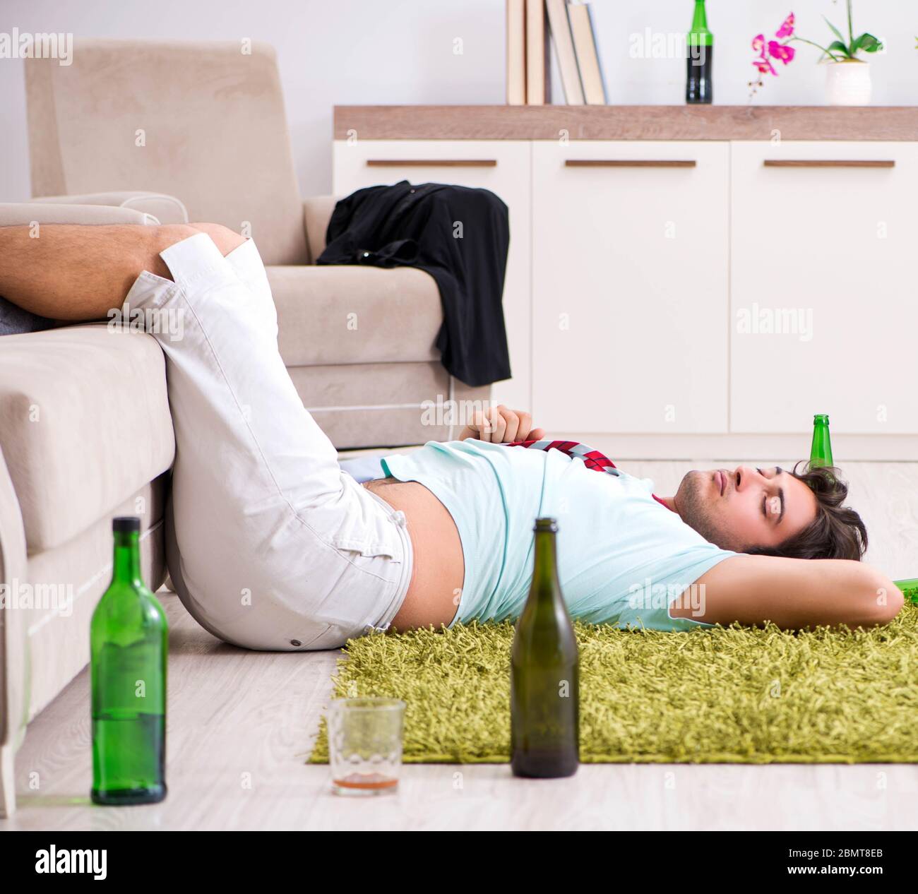 The young drunk handsome man after party at home Stock Photo - Alamy