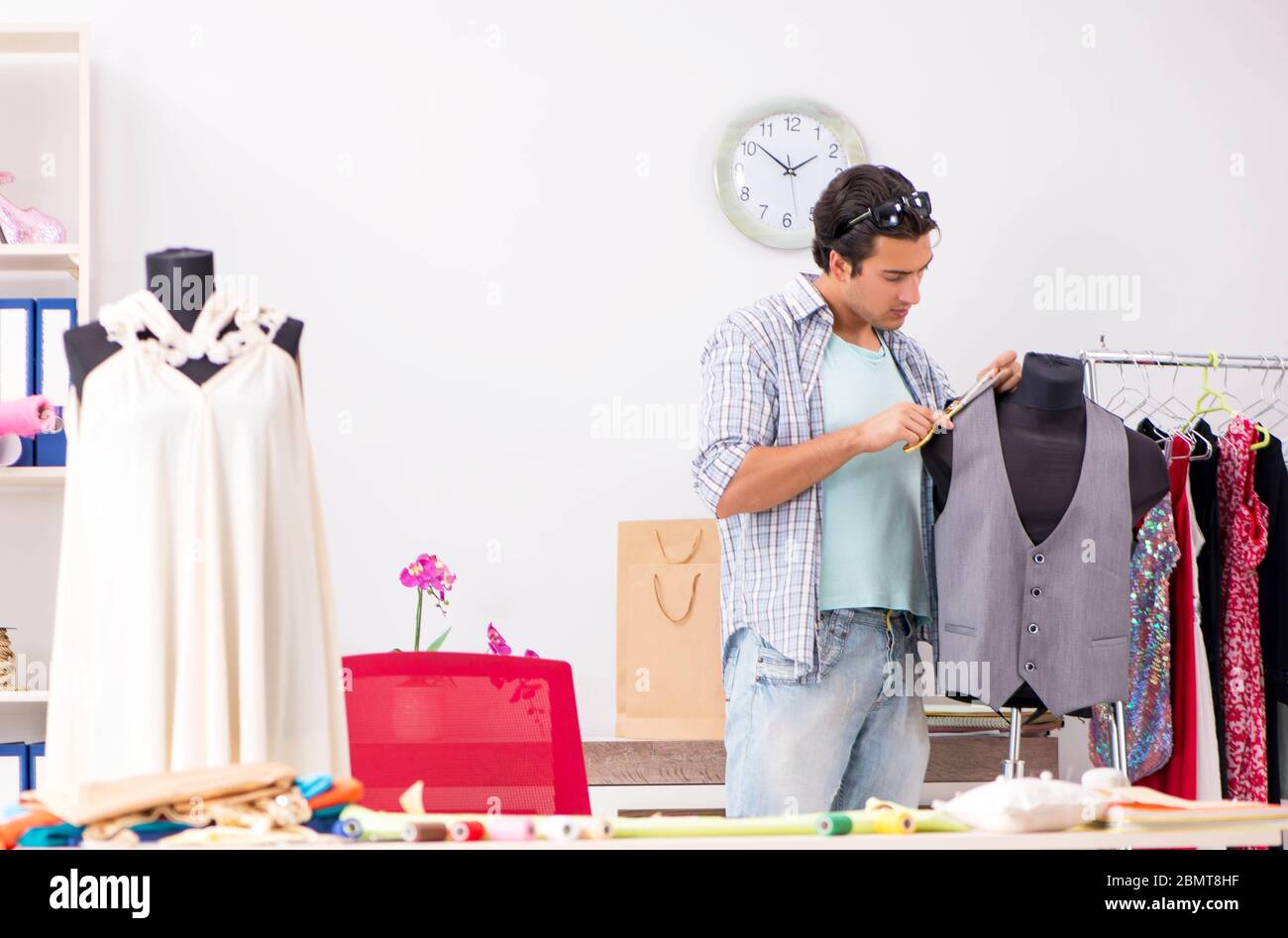 The young handsome tailor working in his workshop Stock Photo - Alamy