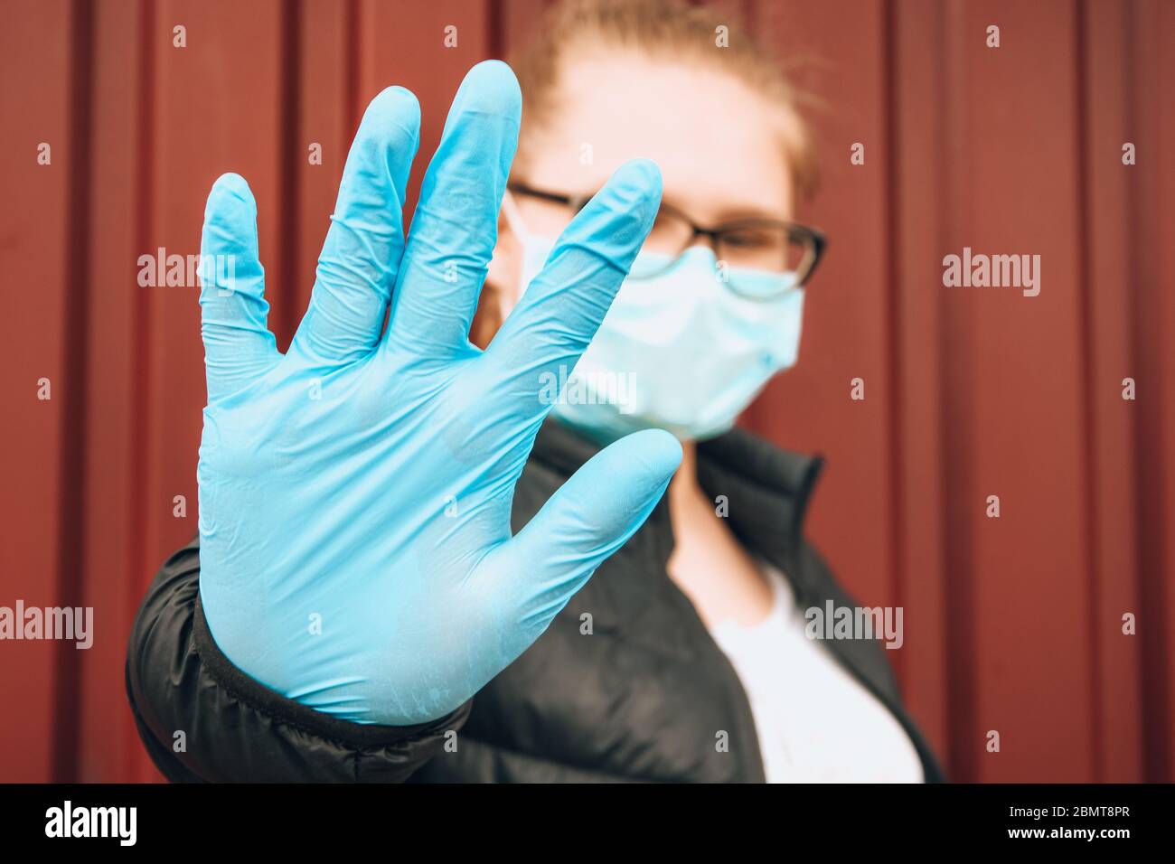 Portrait of a girl in surgical mask and protective gloves. Stop ...