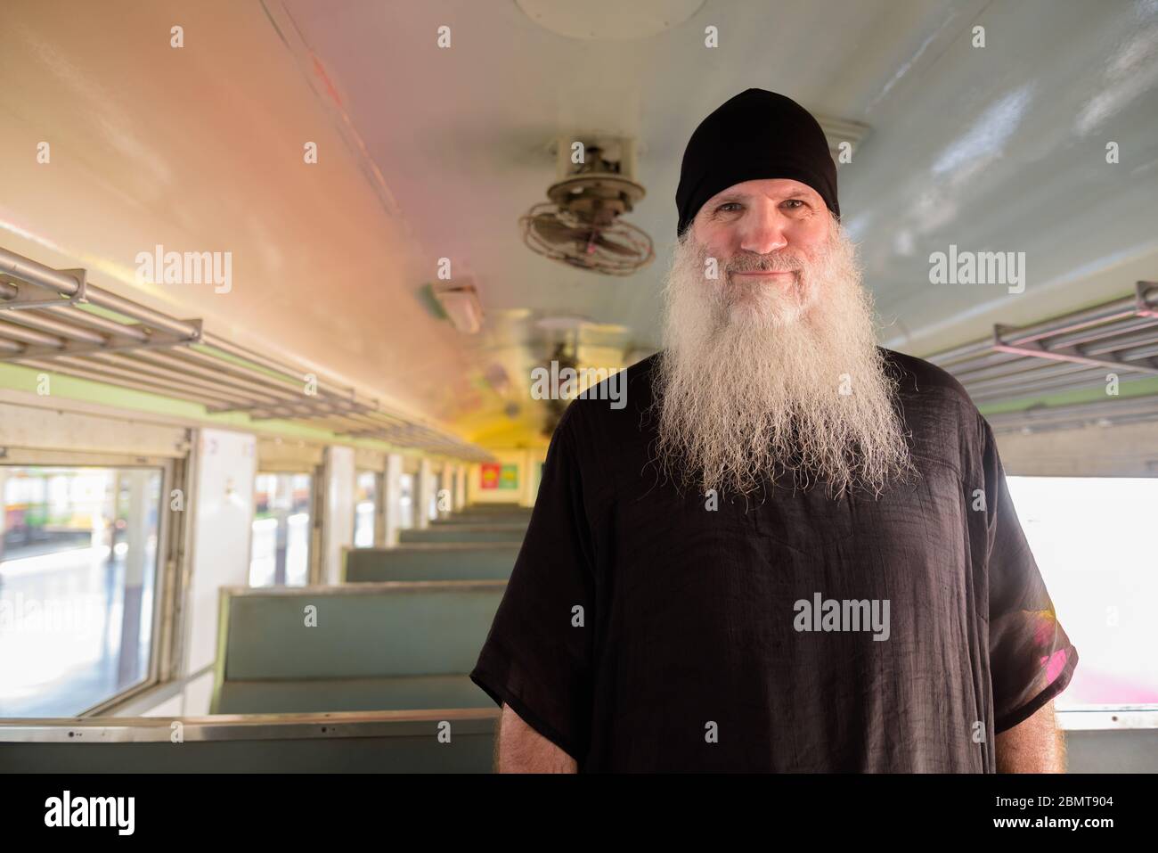 Mature handsome bearded tourist man inside the train Stock Photo - Alamy