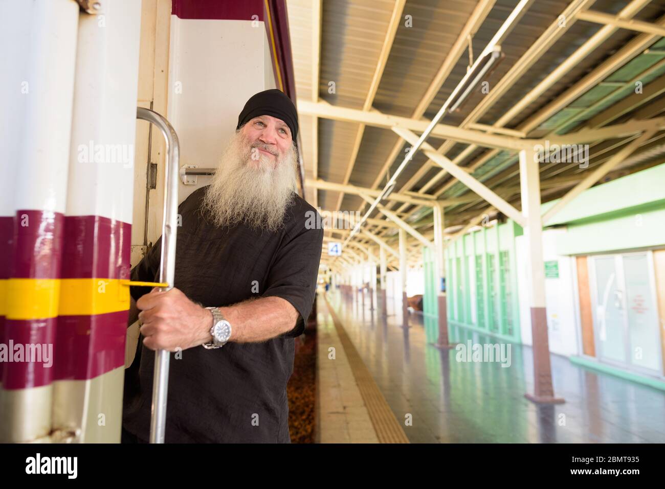 Happy mature bearded tourist man thinking while riding the train Stock ...