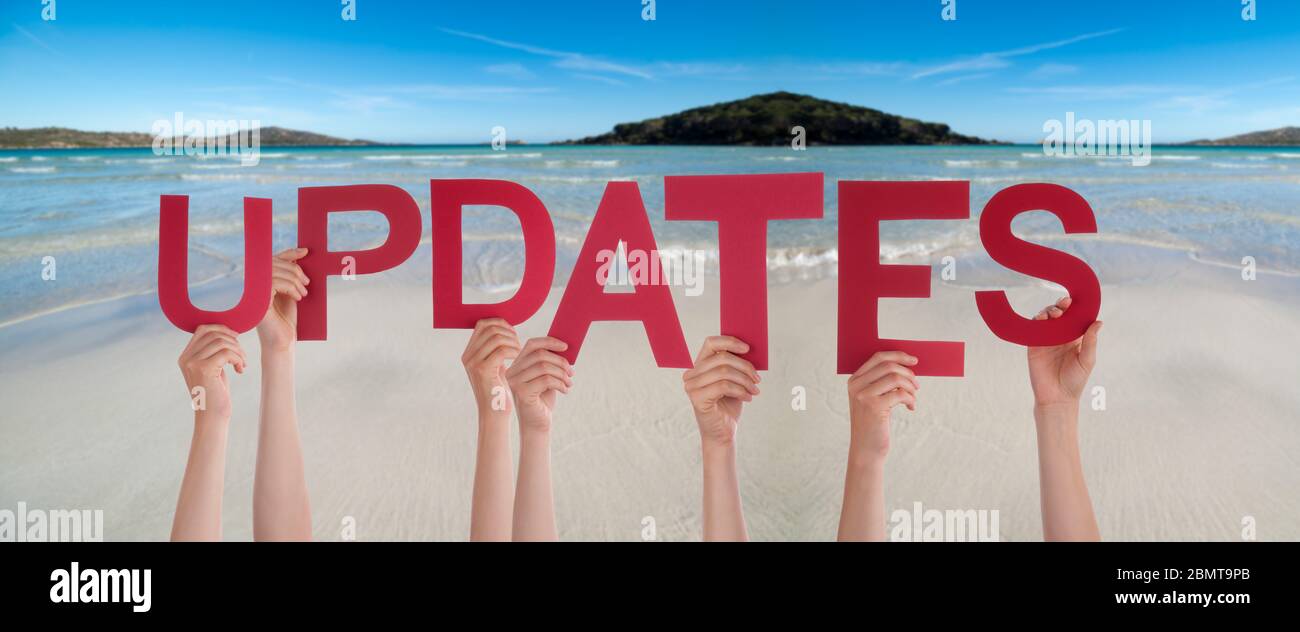 People Hands Holding Word Updates, Ocean Background Stock Photo - Alamy