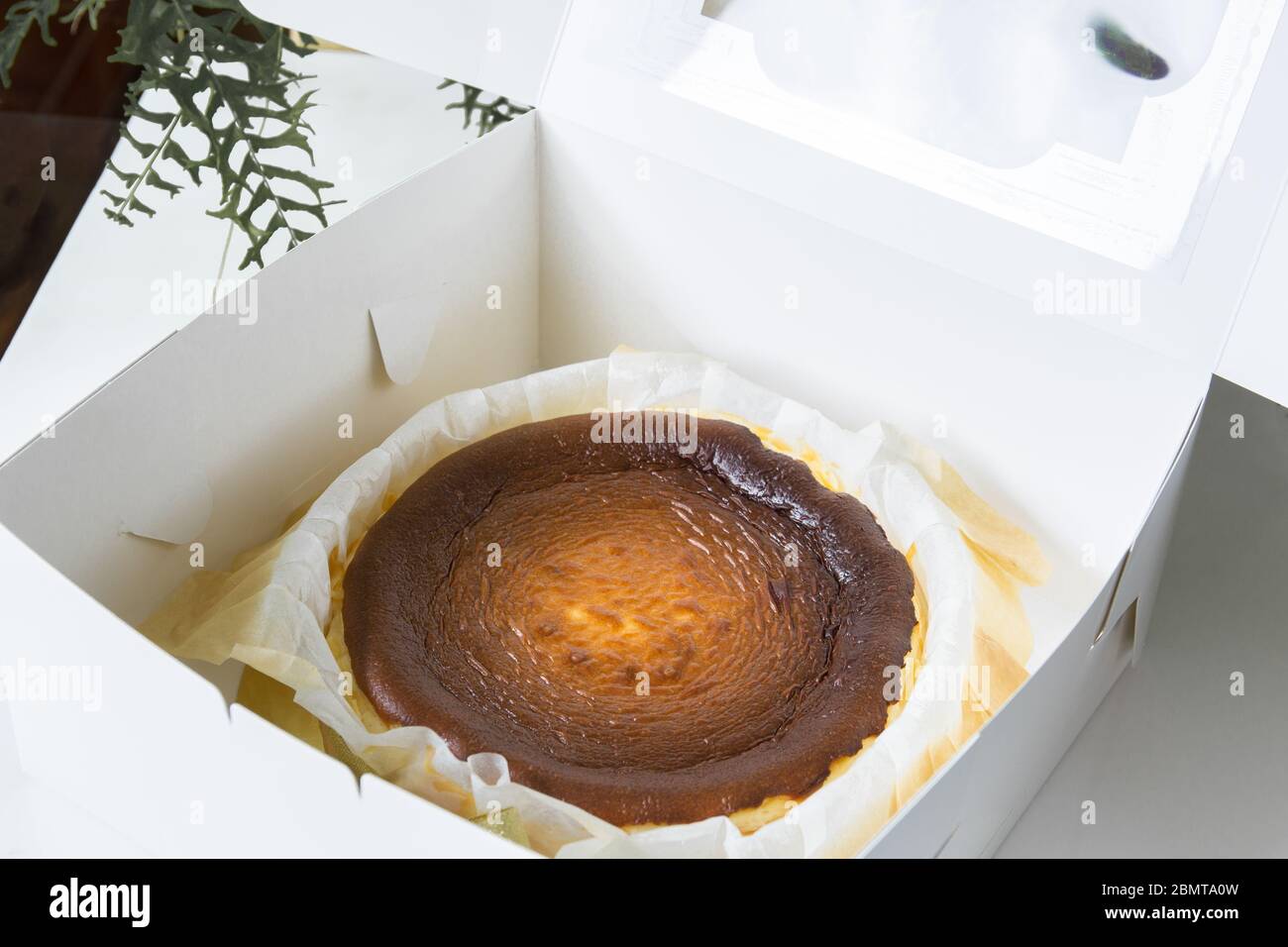 Homemade Basque Burnt Cheesecake in take away box Stock Photo - Alamy