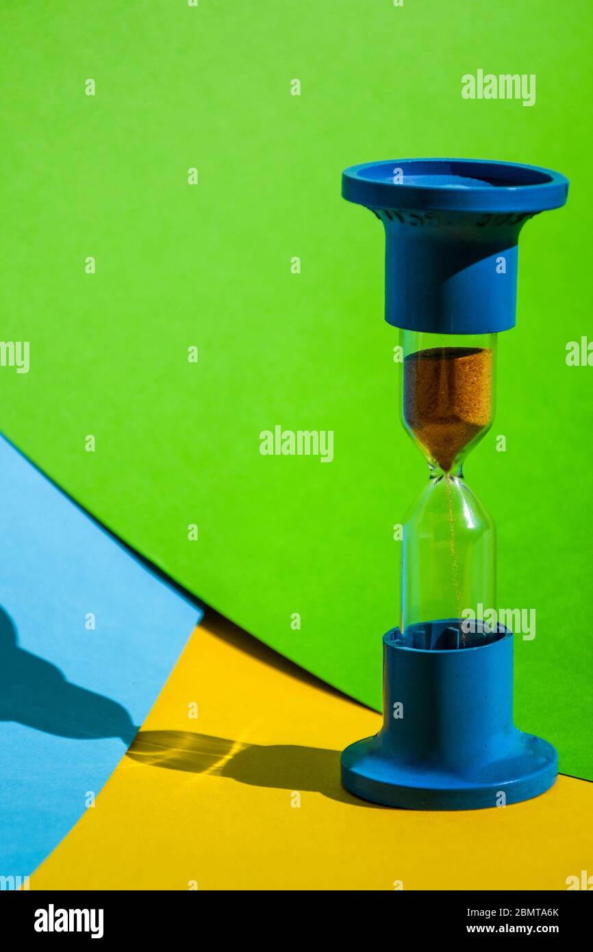 Hourglass colored background, copy space for text, Hourglass shows that ...