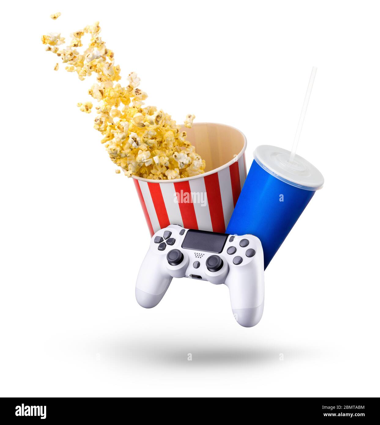 Paper bucket with popcorn, cup of drink and video game joystick on ...