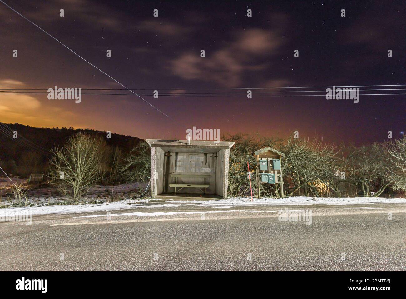 Bus stop and post boxes at night Stock Photo - Alamy