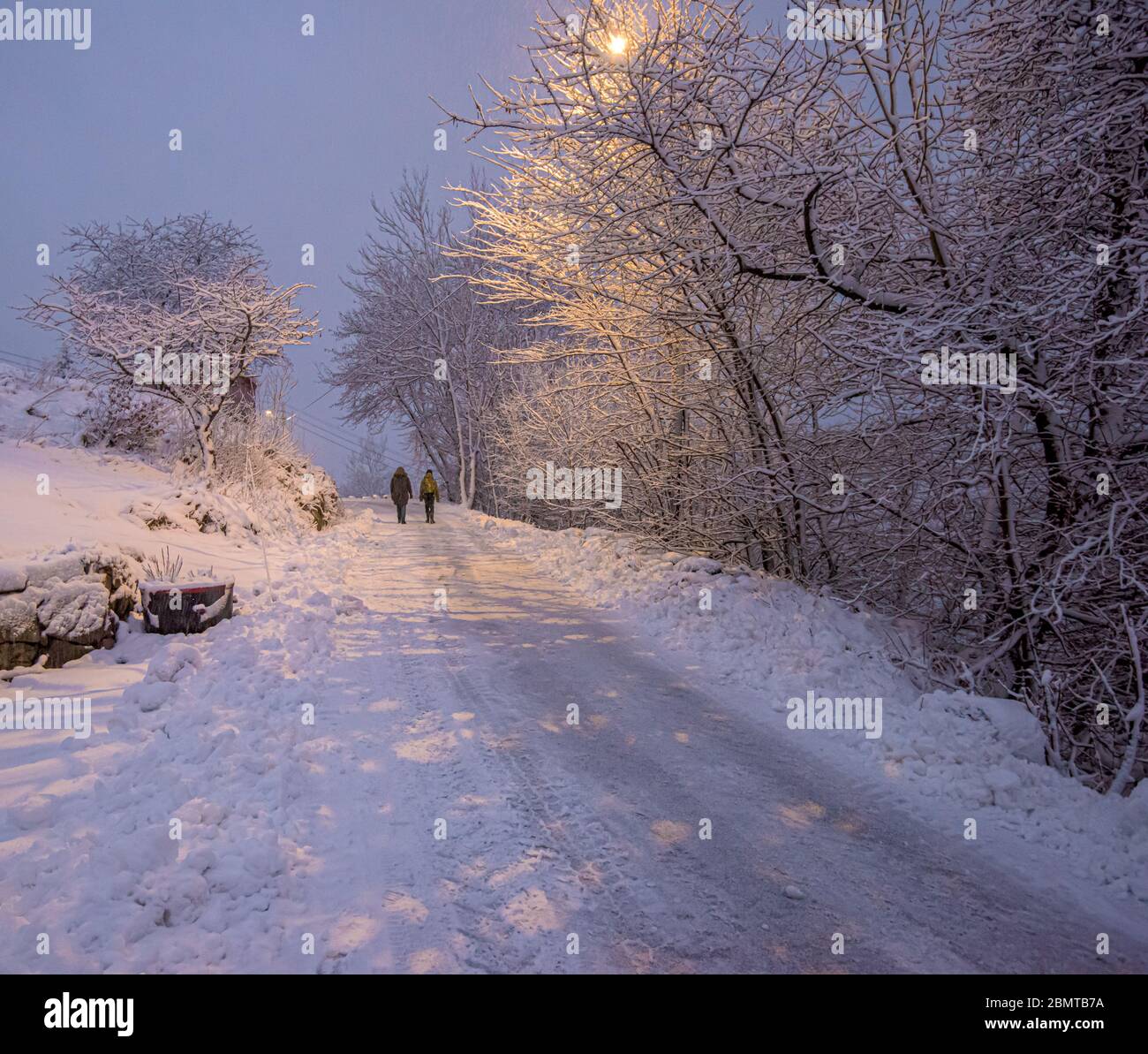 Persons walking on snowy street hi-res stock photography and images - Alamy