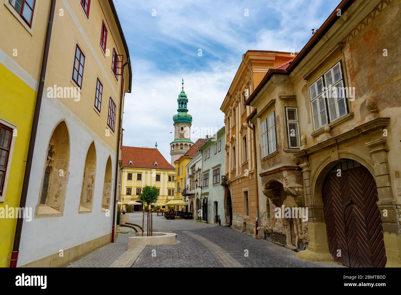 narrow medieval street of Sopron with the fire watch tower in the ...