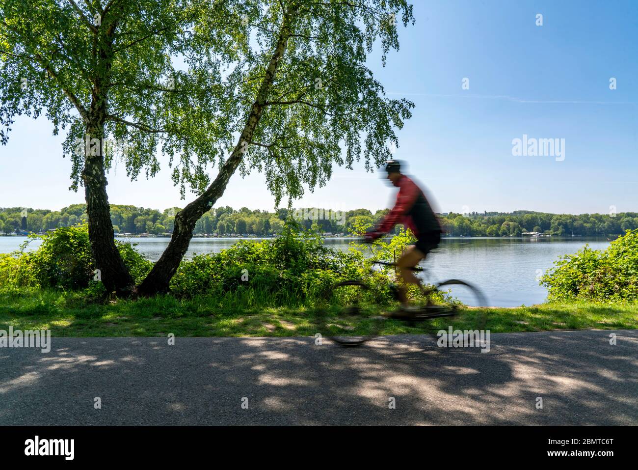 Cycling on the river Ruhr, lakeside path at Lake Baldeney in Essen, NRW ...