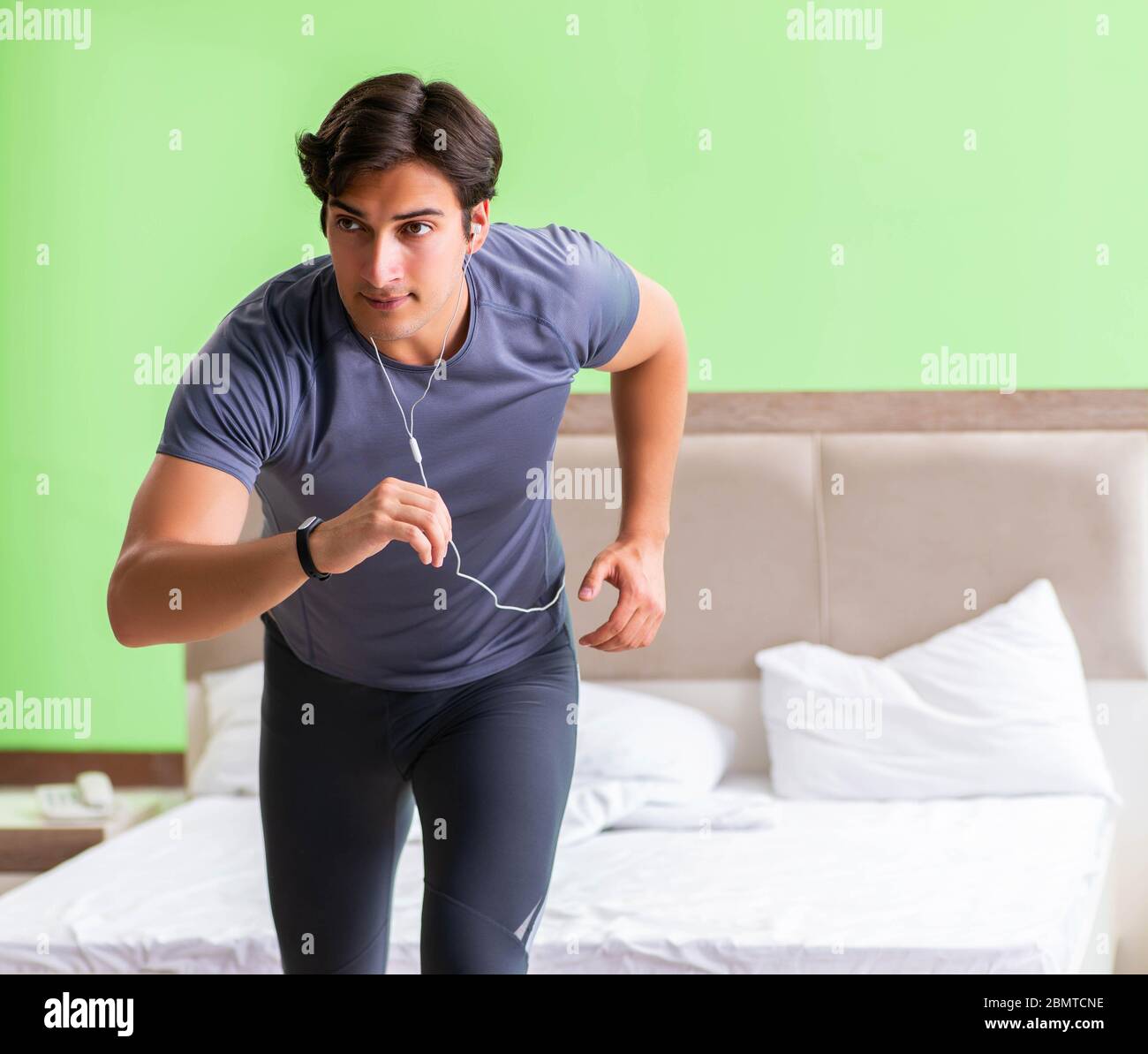 The young handsome man doing morning exercises in the hotel room Stock ...