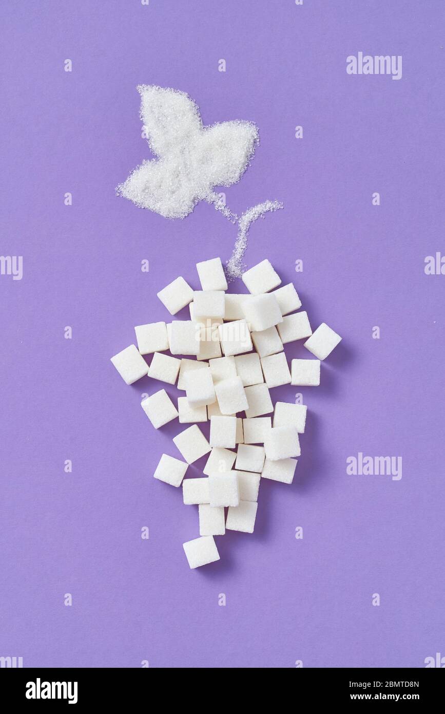 Refined sugar cubes as a grape fruit with leaf from granulated sugar ...
