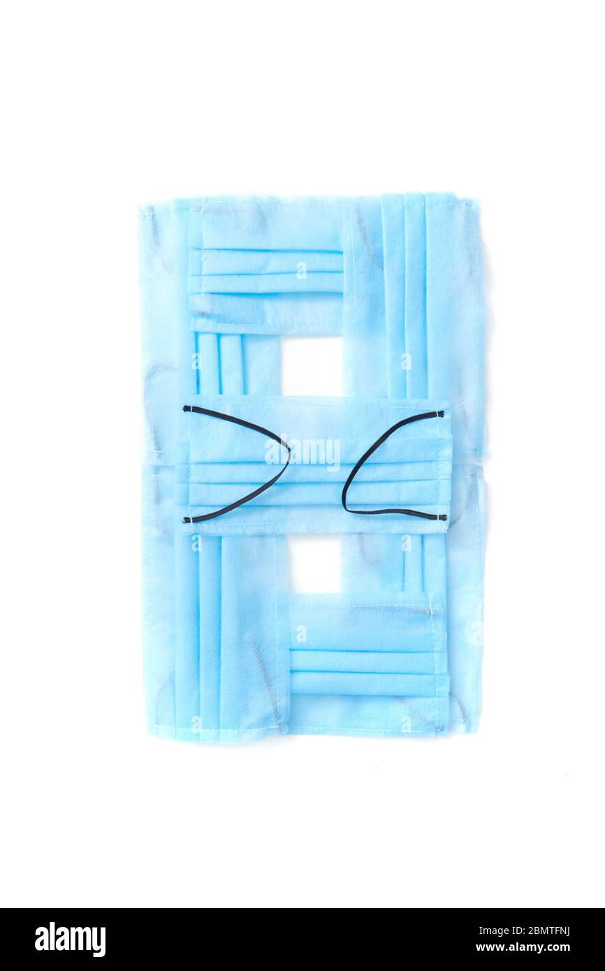 Number eight made from protective medical masks on a white background ...