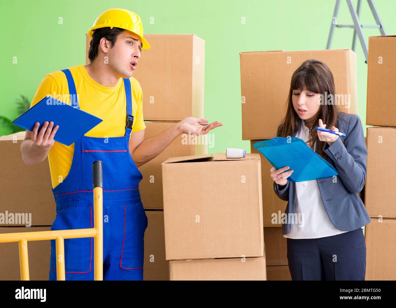 The woman boss and man contractor working with boxes delivery Stock ...