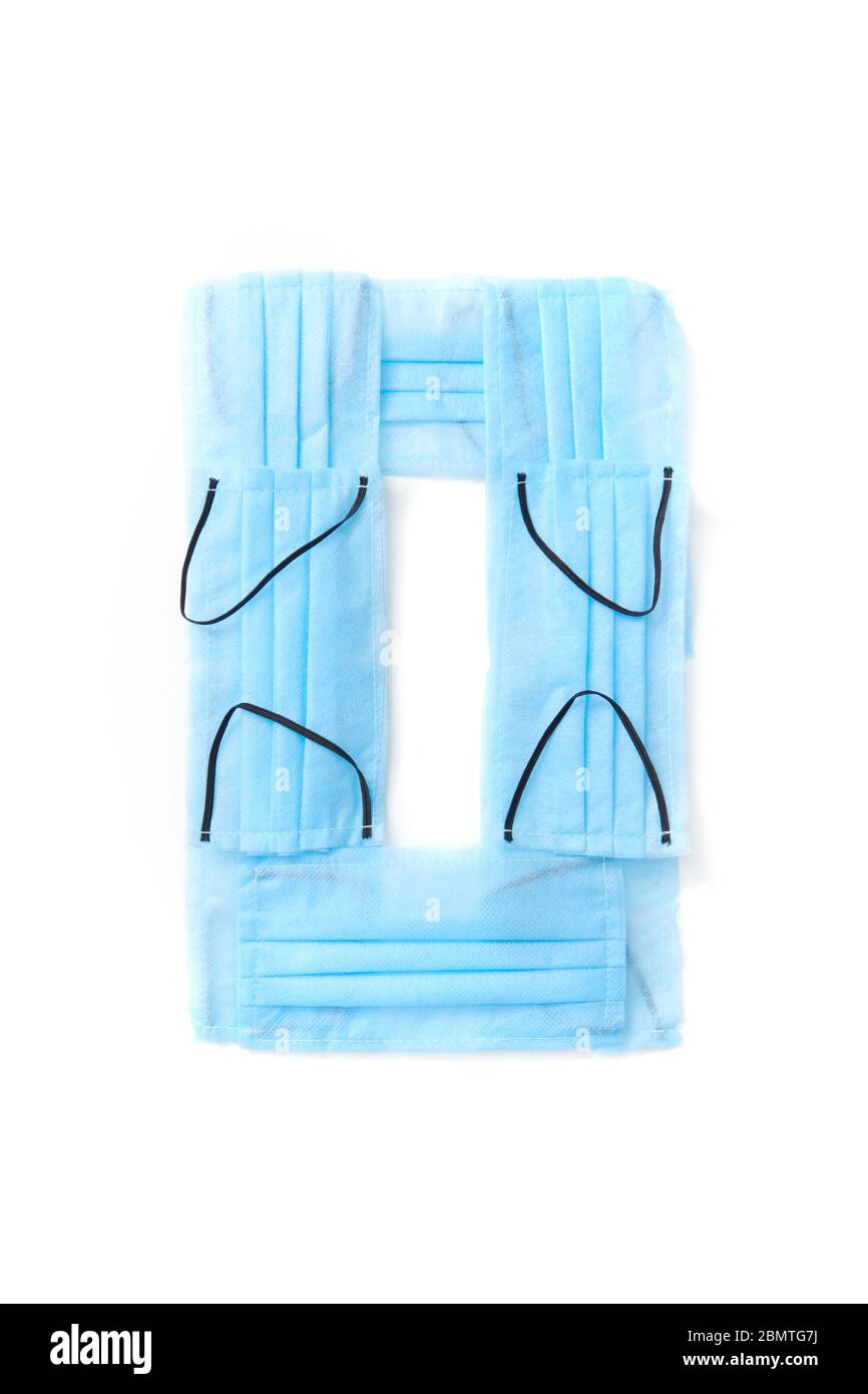 Number zero made from protective medical masks on a white background ...