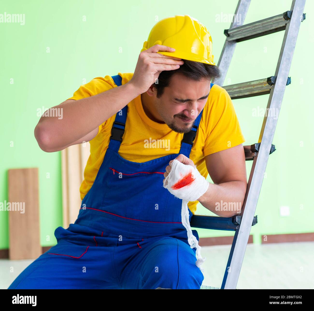 The injured worker at the work site Stock Photo - Alamy