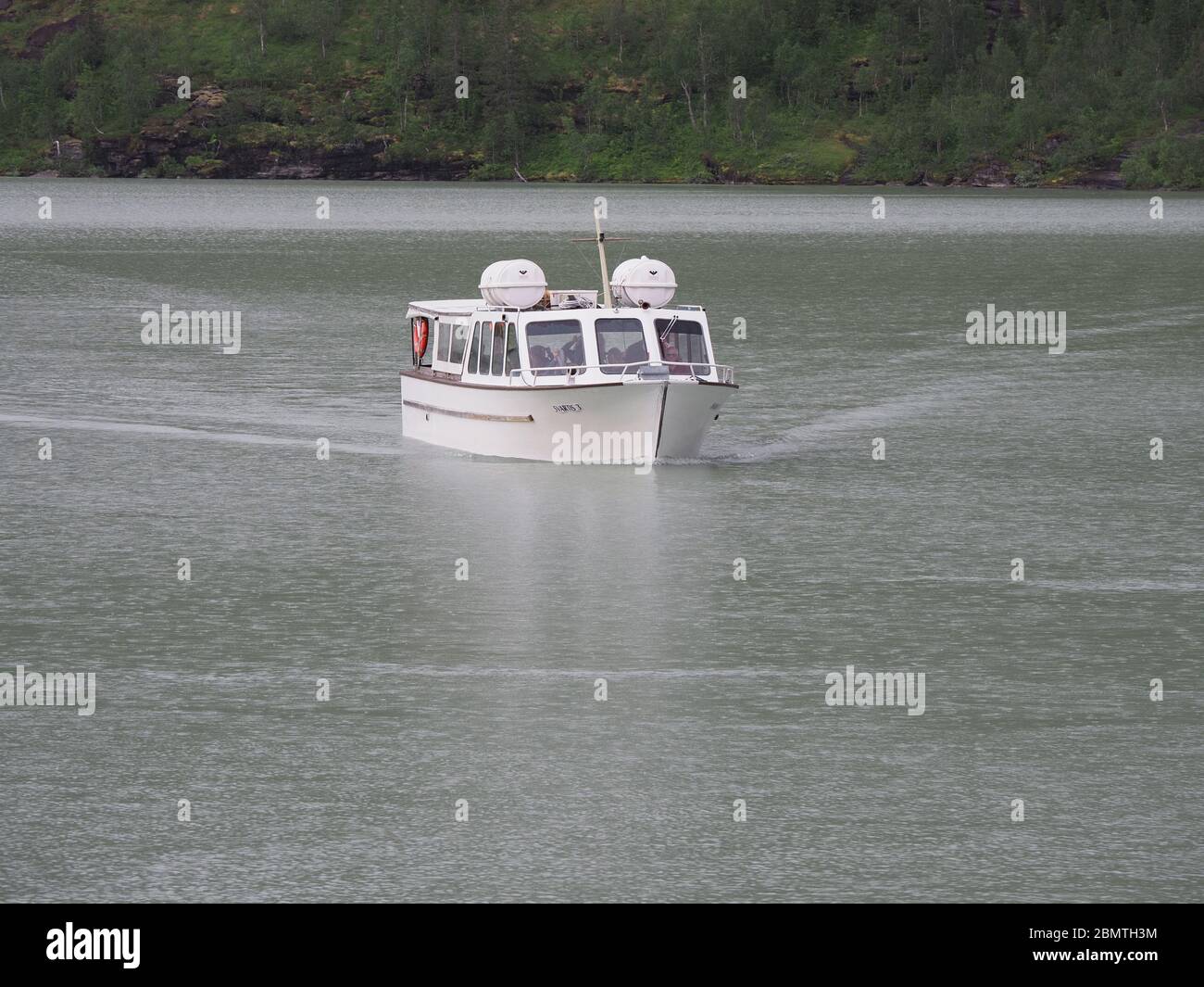 Nordic view to white touristic boat on Svartisvatnet lake in Norway ...