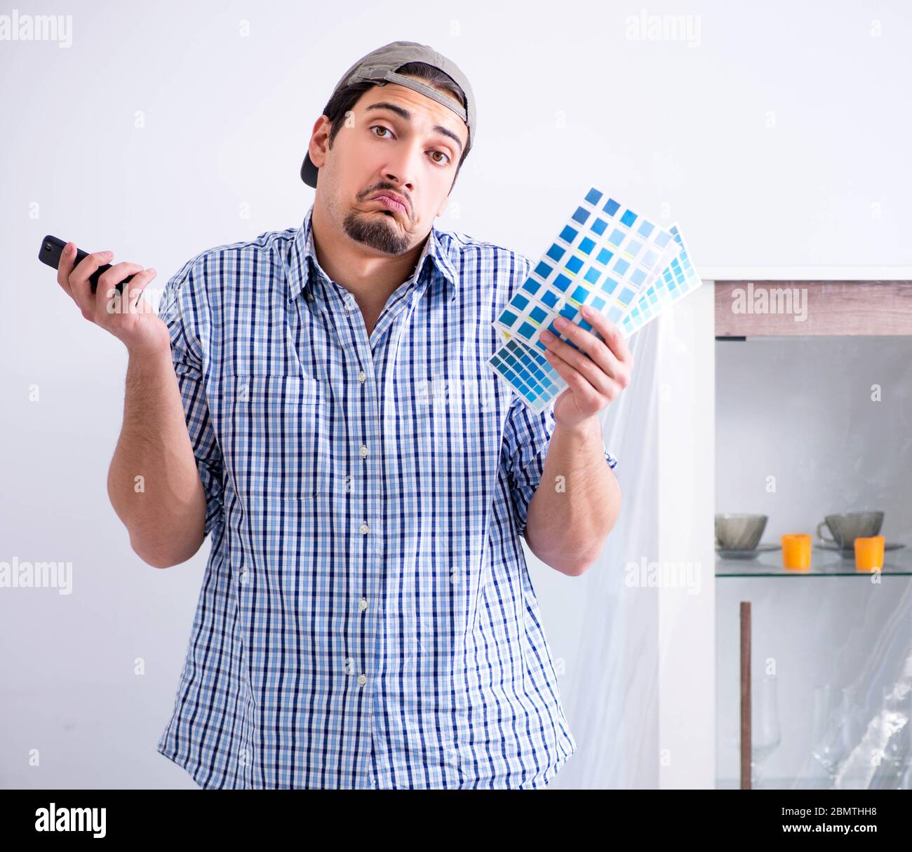 The young man contractor choosing color from rainbow Stock Photo - Alamy