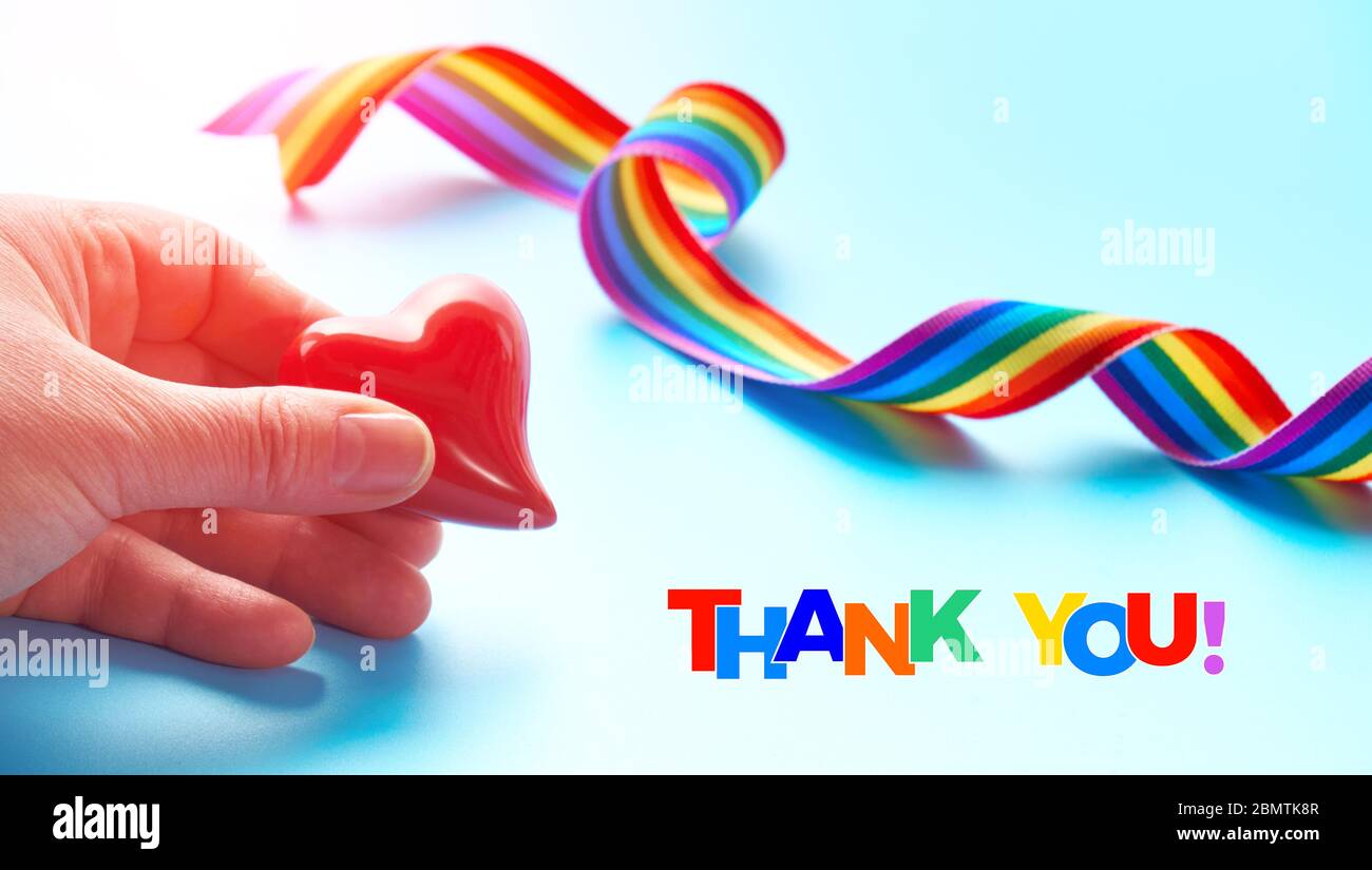 Red heart and curled rainbow ribbon. Rainbow text "Thank you NHS" on ...