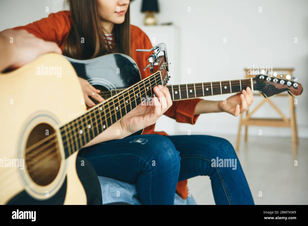 Learning to play the guitar. The teacher explains to the student the ...