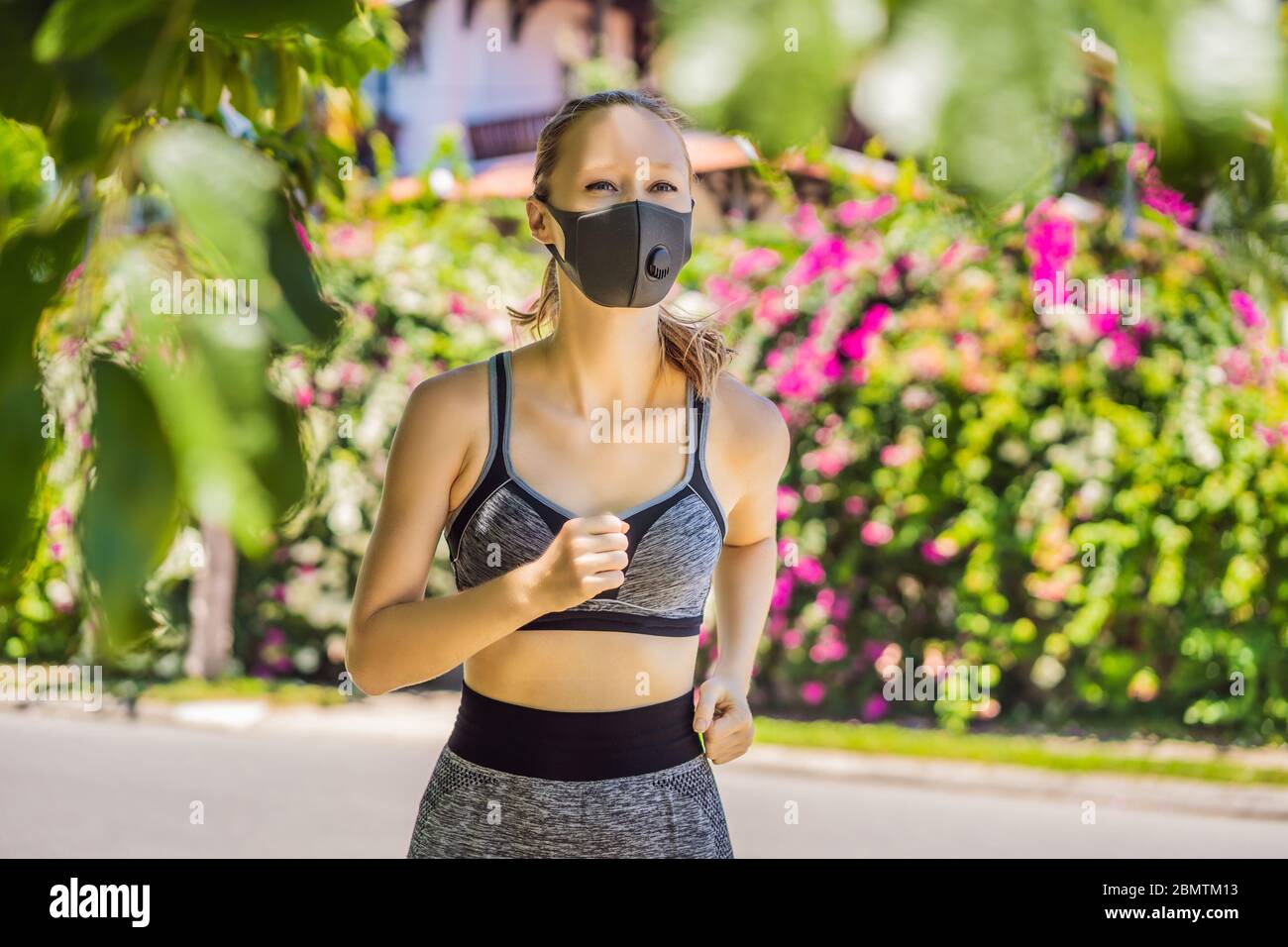 Woman runner wearing medical mask. Running in the park. Coronavirus ...