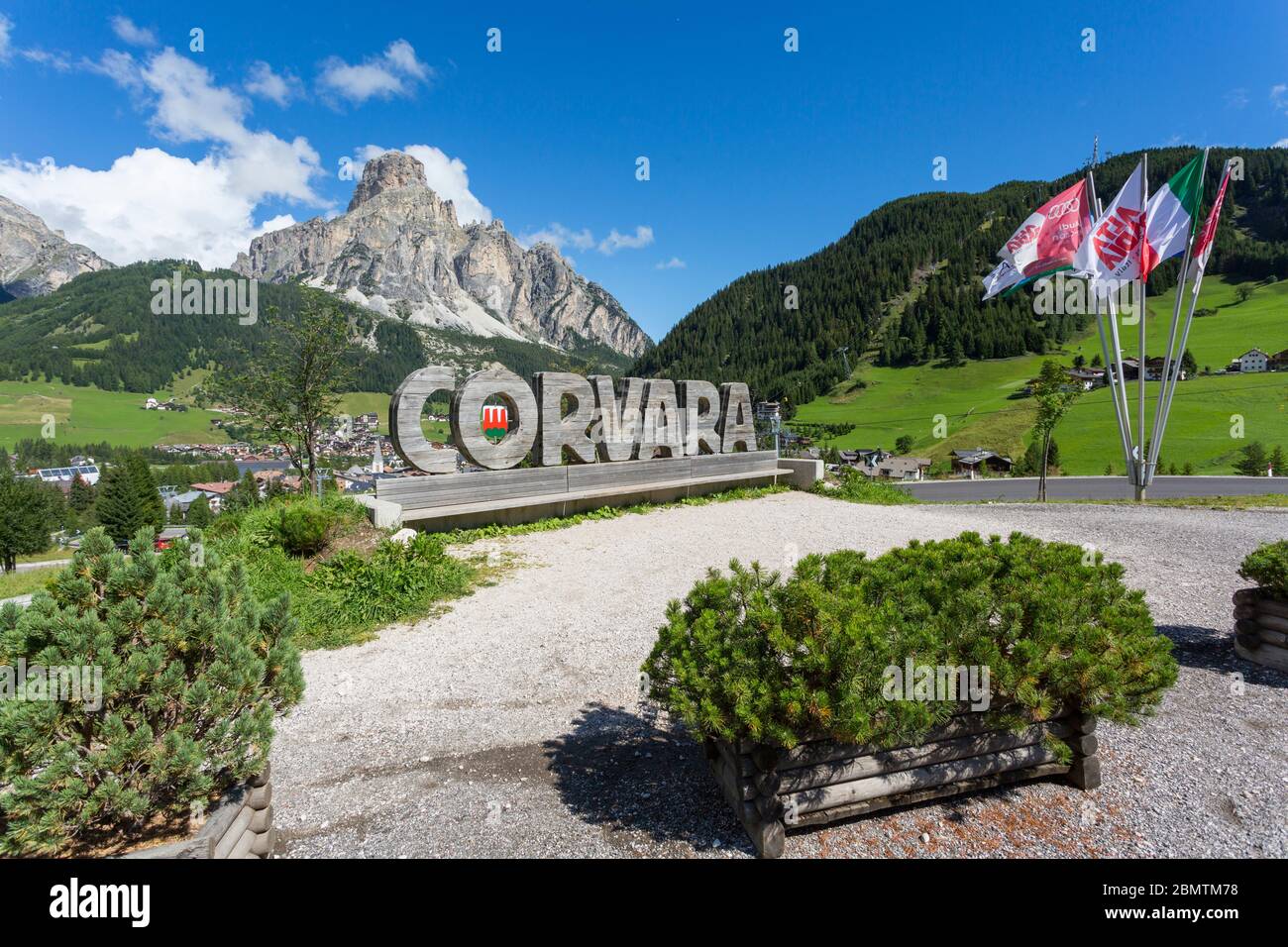 View toward Corvara and wooden 'Corvara' sign, Alta Badia, Corvara ...