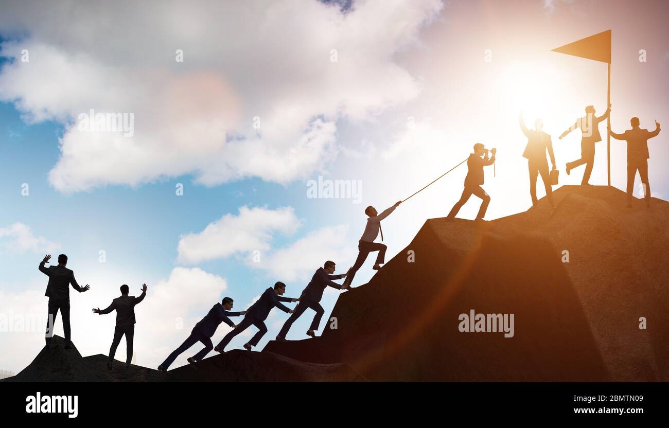 Concept of teamwork with team climbing mountain Stock Photo - Alamy