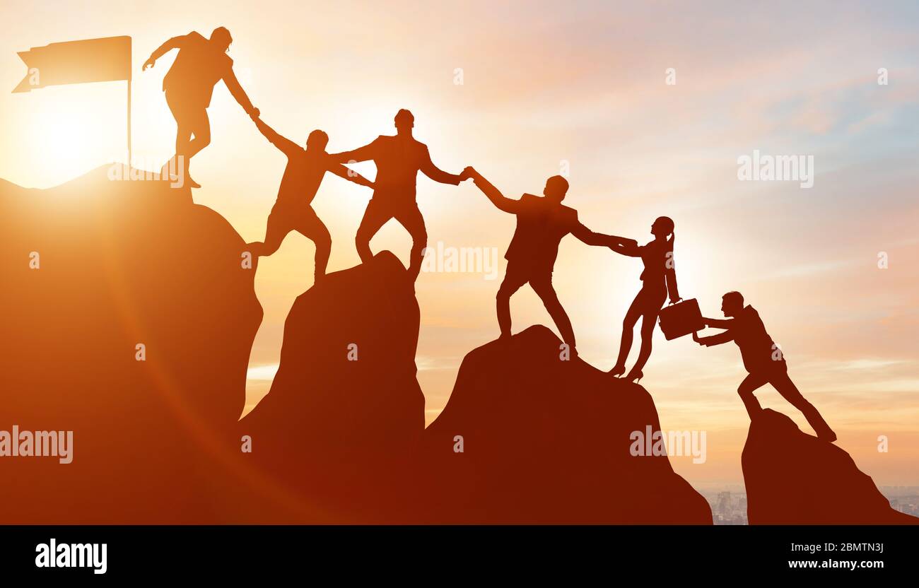 Concept of teamwork with the team climbing mountain top Stock Photo - Alamy
