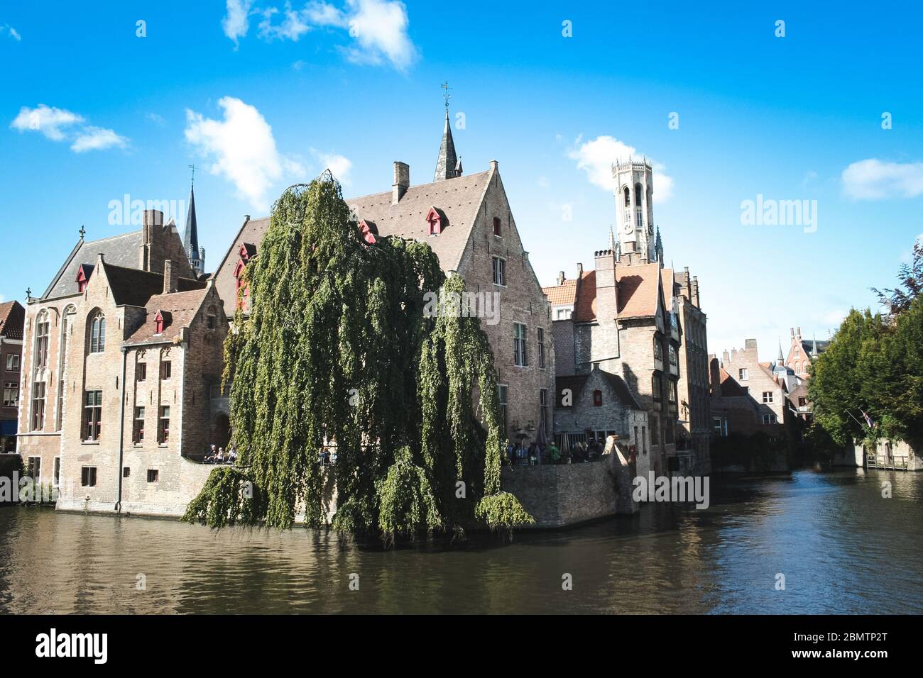 View of a medieval building with trees along a water channel Stock ...