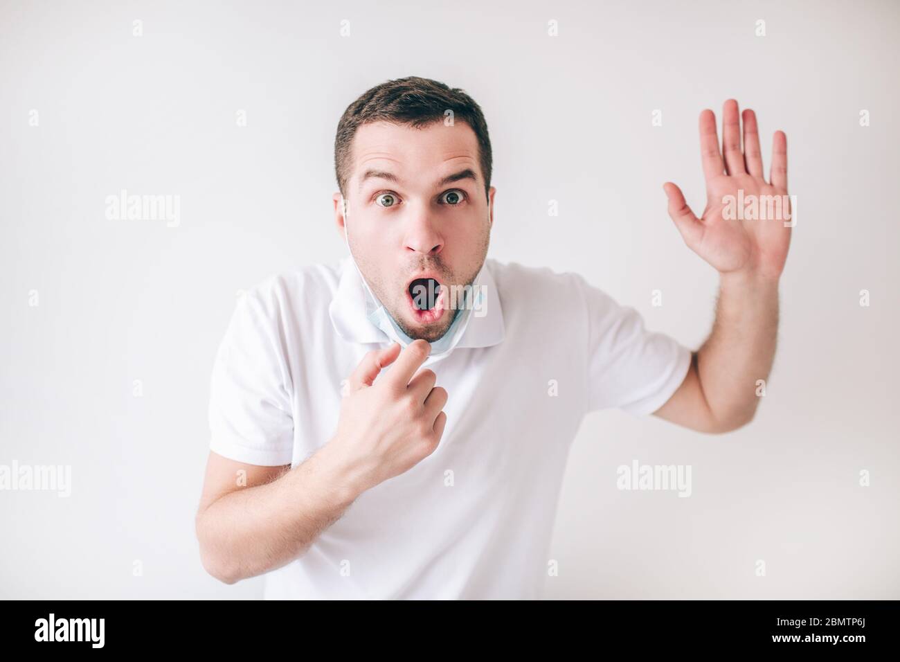 Young sick man isolated over white background. Guy coughing badly and ...