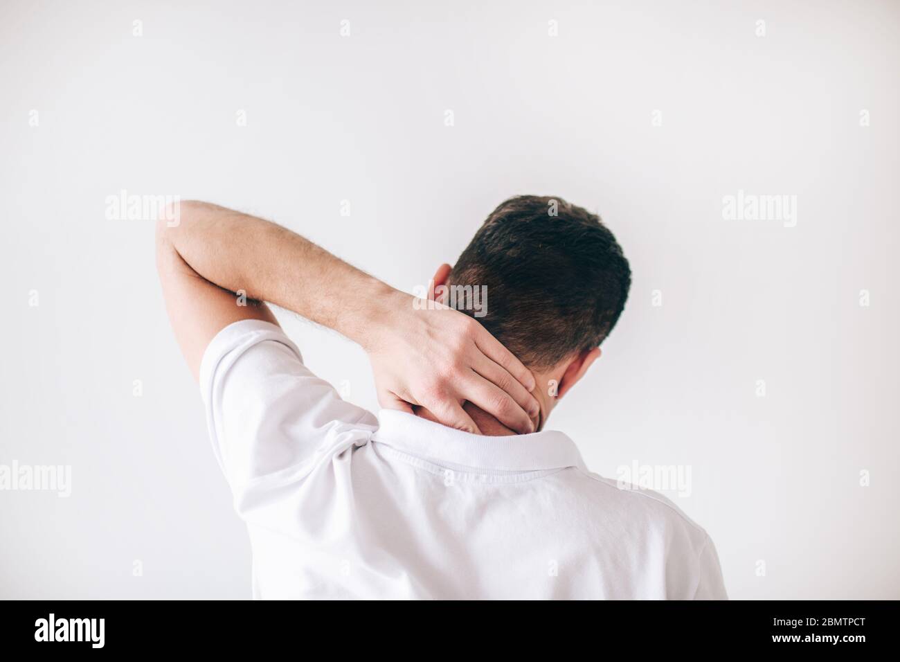 Young man isolated over white background. Back view of guy having ...