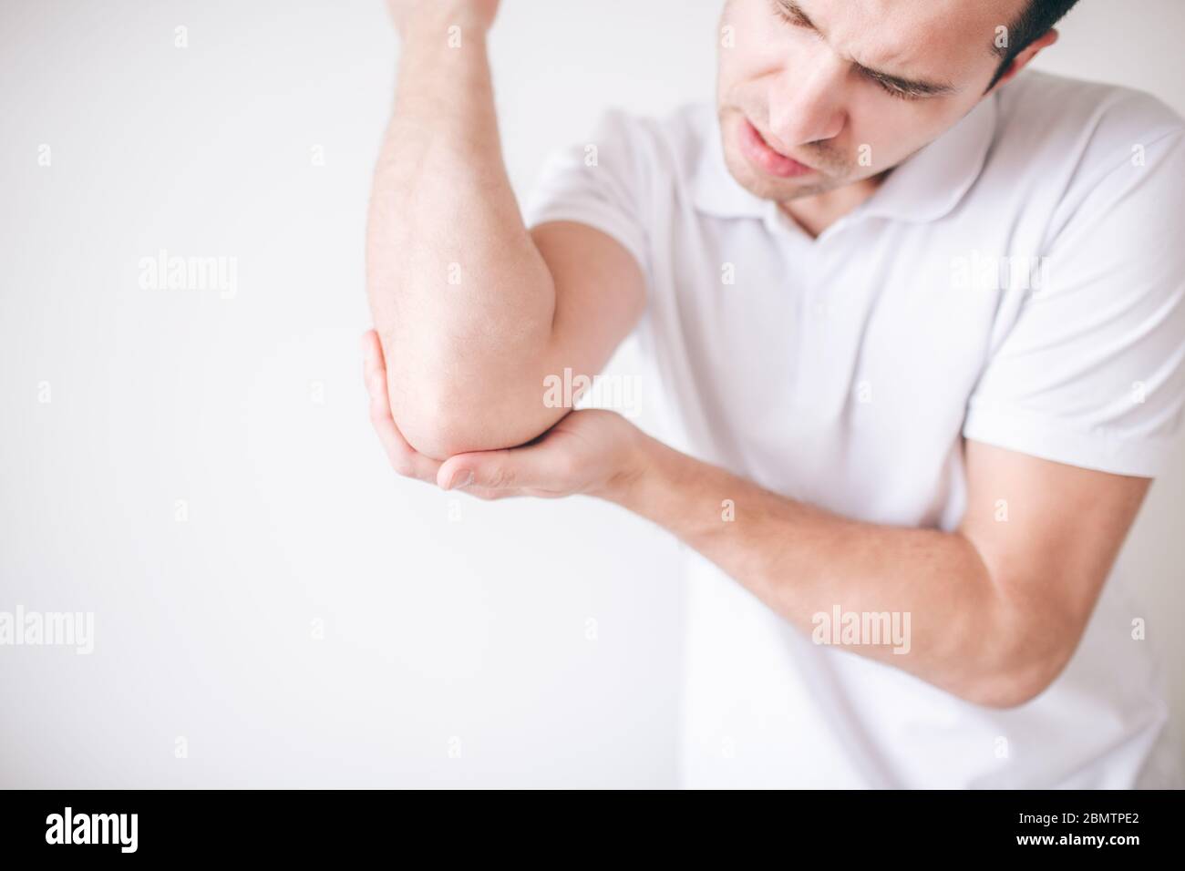 Young man isolated over white background. Picture concept of pain in ...