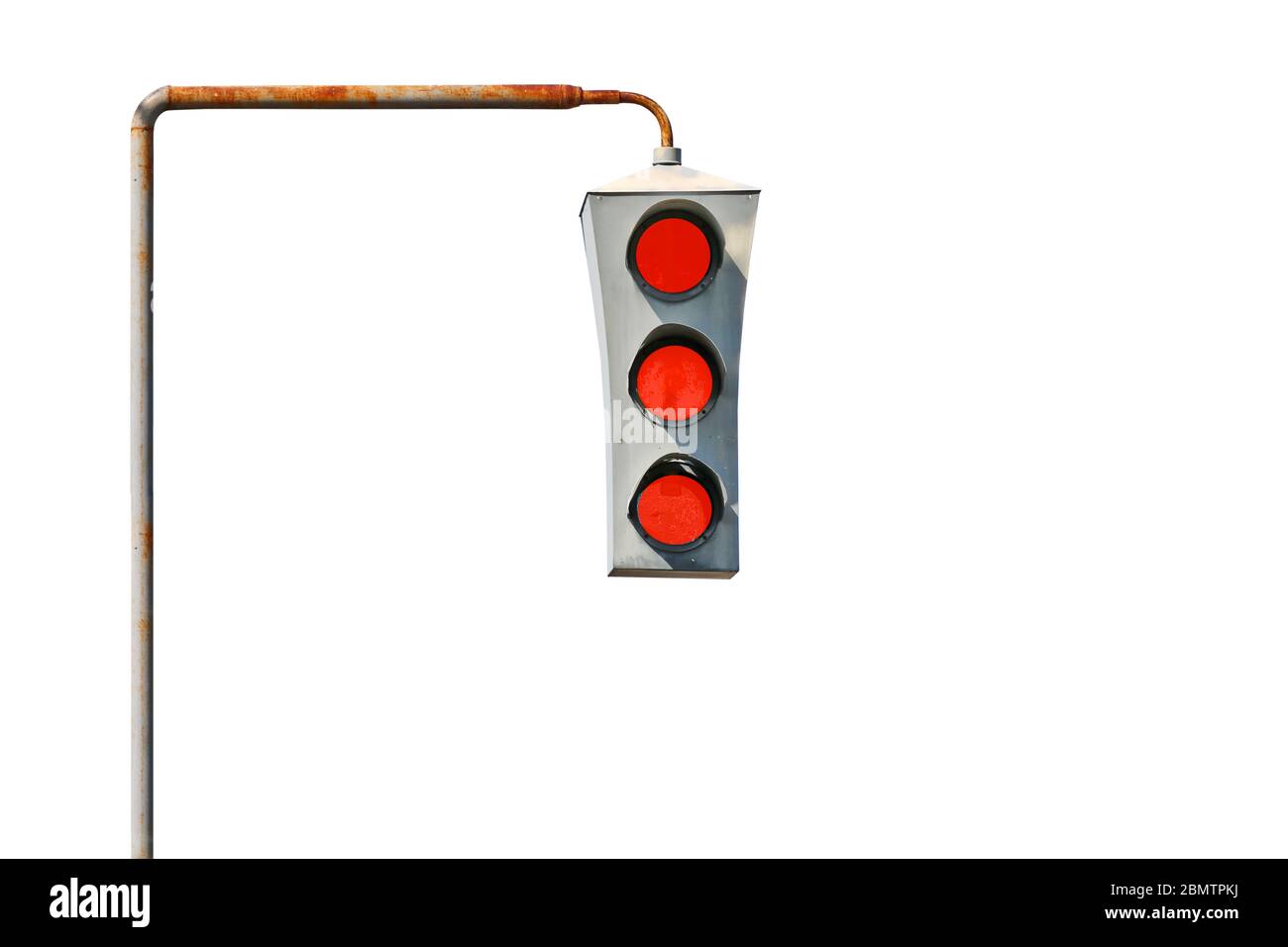 Isolated Vintage old traffic light on a rusty post. All lights are red ...