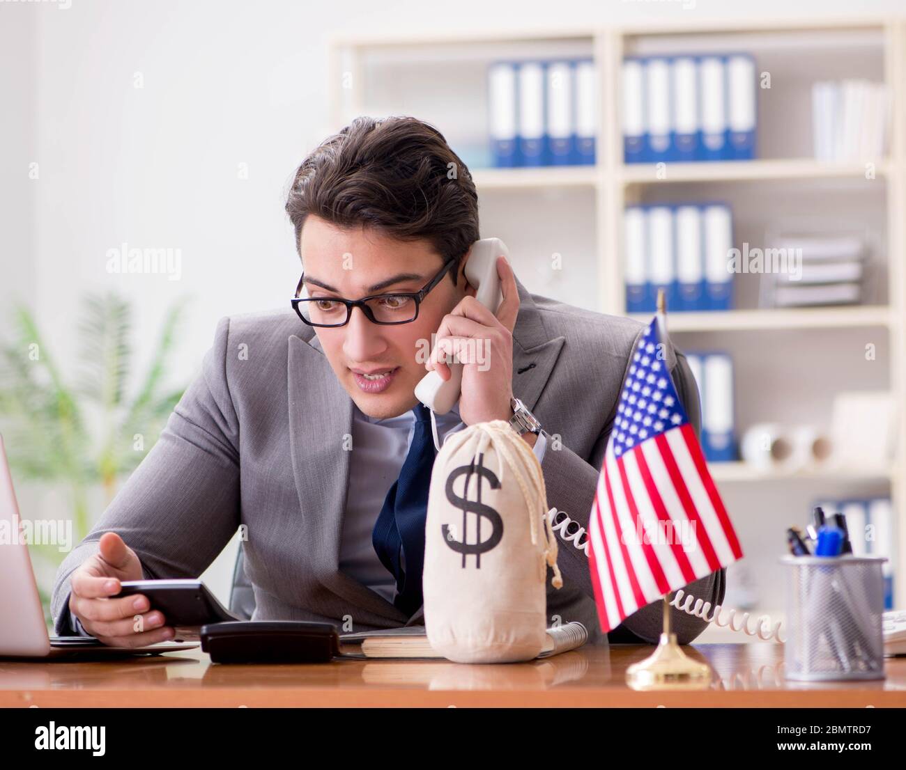 The businessman with american flag in office Stock Photo - Alamy