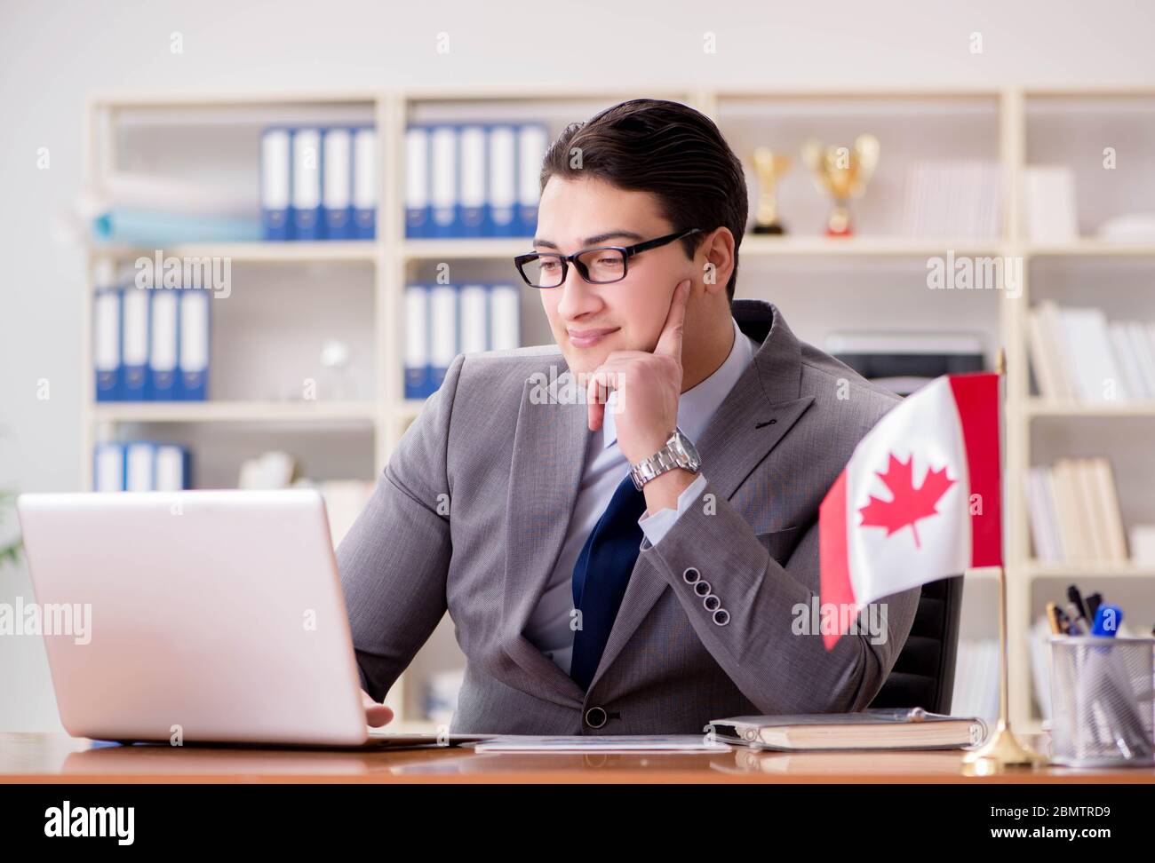 The businessman with canadian flag in office Stock Photo - Alamy