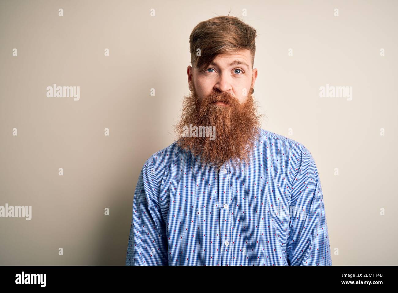 Handsome Irish redhead business man with beard standing over isolated ...