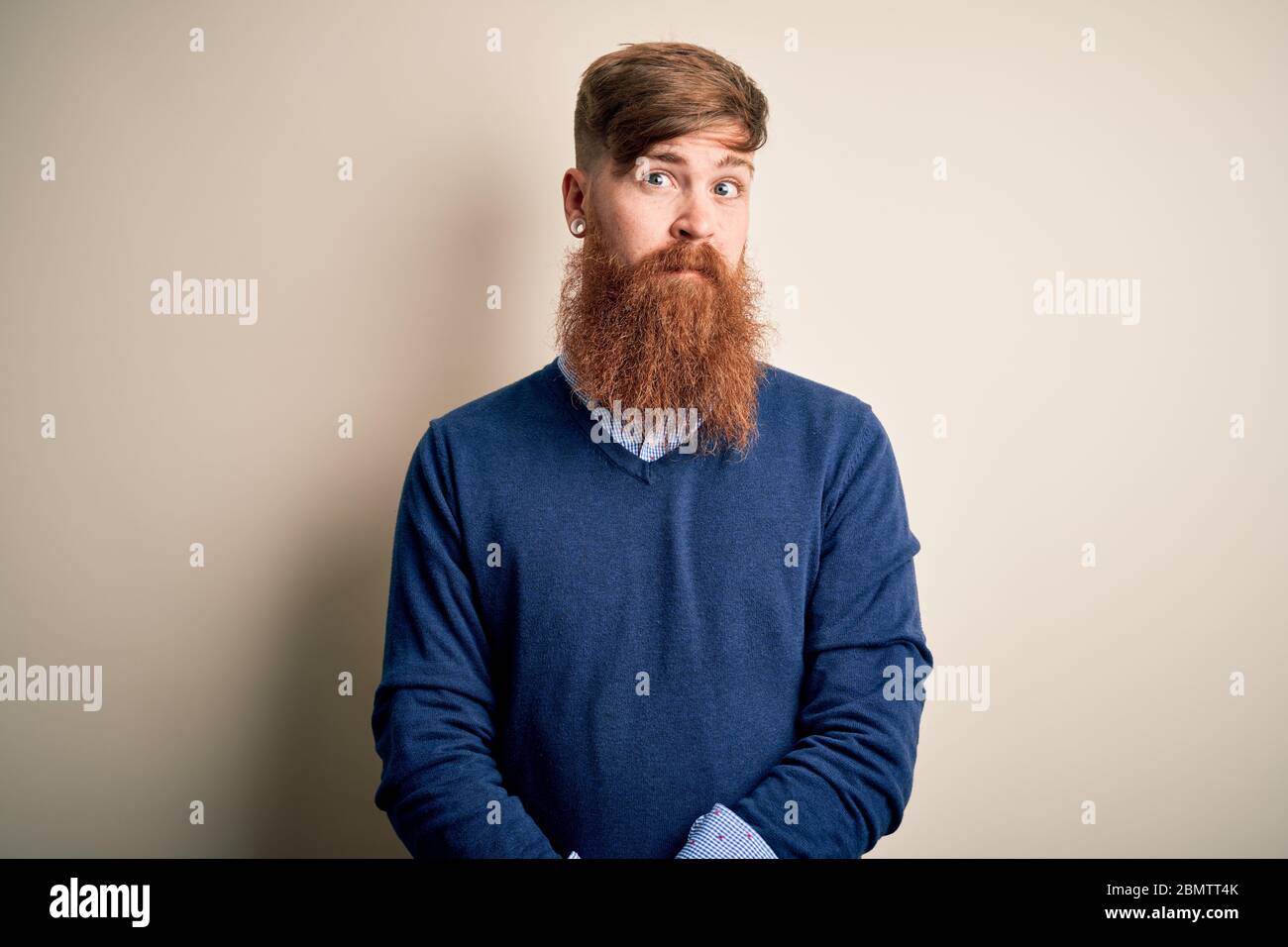 Handsome Irish redhead business man with beard standing over isolated ...