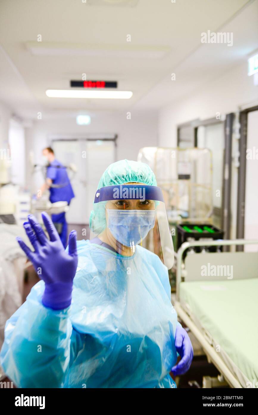 Cheerful Doctor wearing disposable coverall with mask and safety google ...