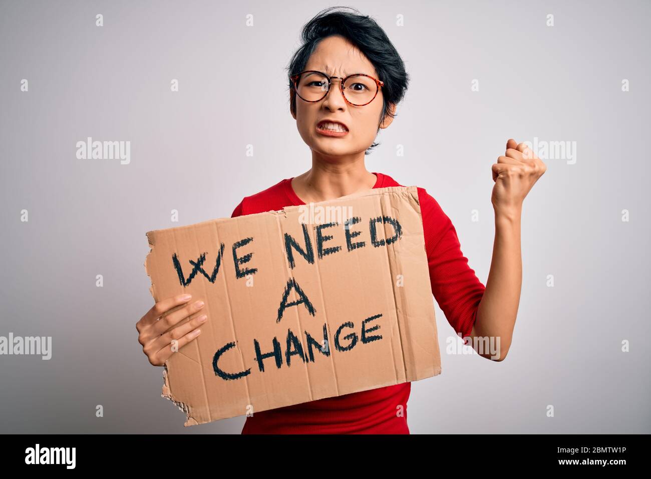 Beautiful asian girl protesting holding banner with change message over ...