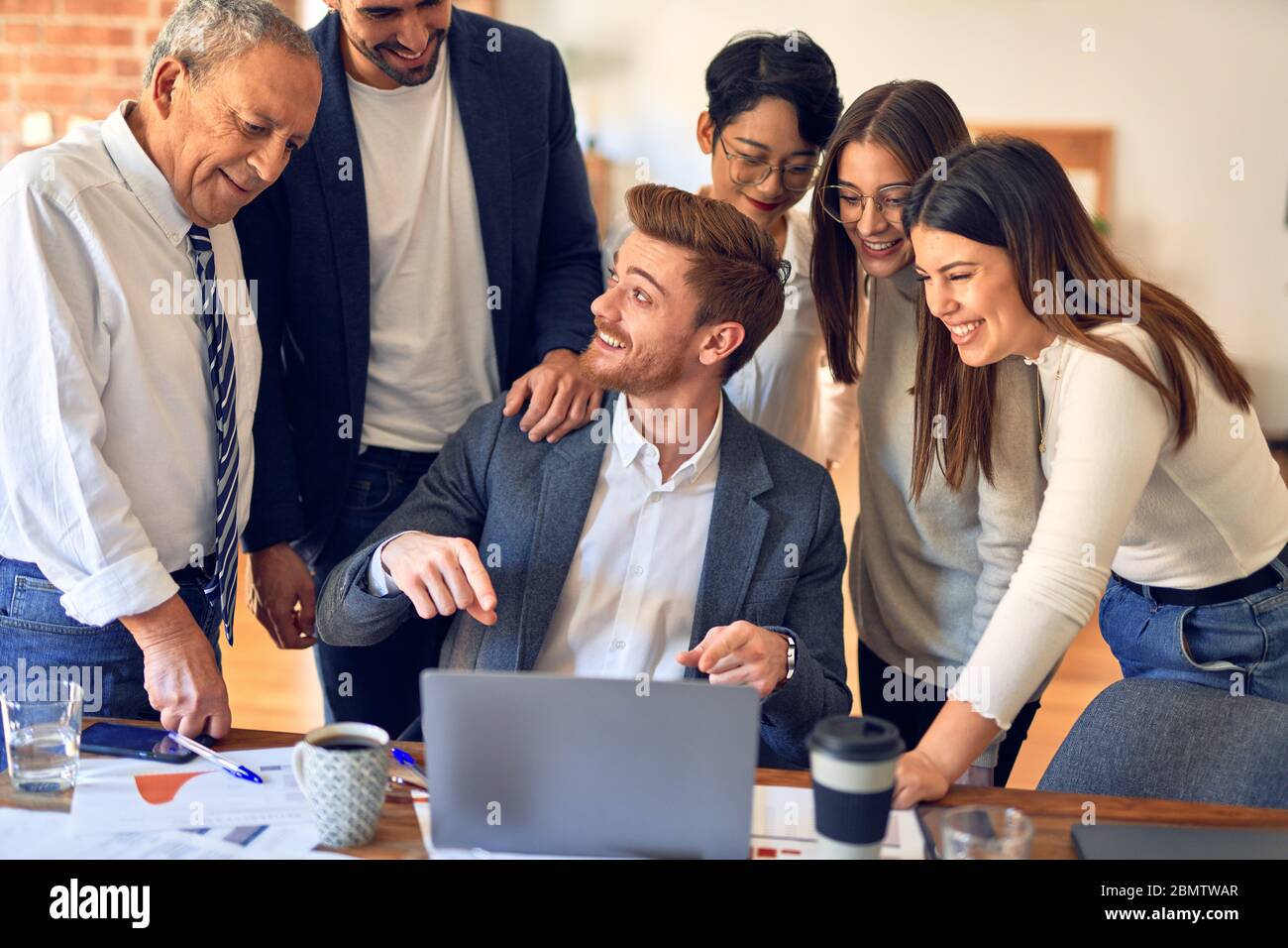 Group of business workers smiling happy and confident. One of them ...