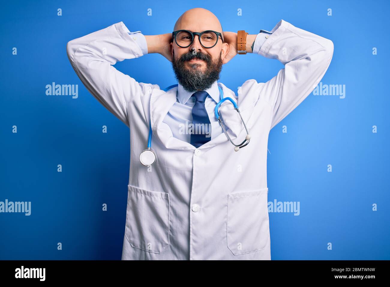 Handsome bald doctor man with beard wearing glasses and stethoscope ...