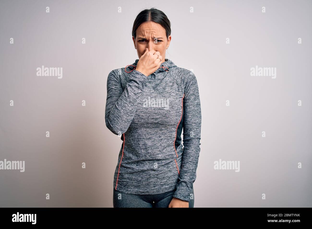 Young blonde fitness woman wearing sport workout clothes over isolated ...