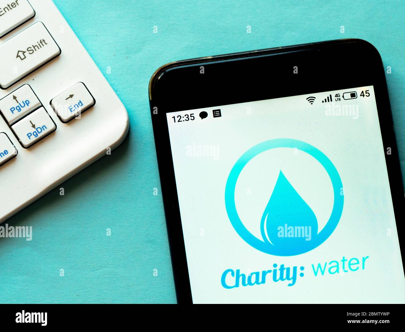 In this photo illustration Charity: Water logo is seen displayed on a ...