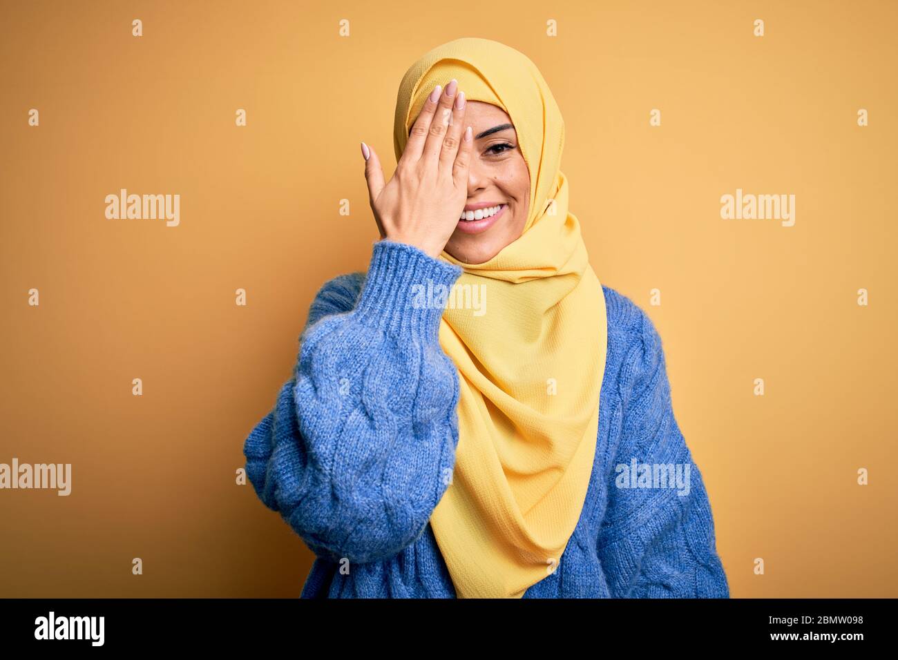 Young beautiful brunette muslim woman wearing arab hijab over isolated ...