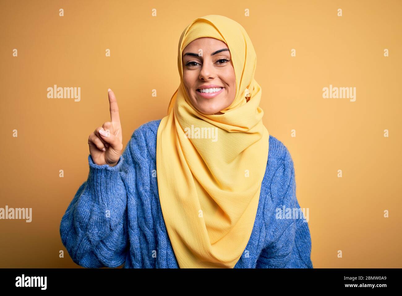 Young beautiful brunette muslim woman wearing arab hijab over isolated ...