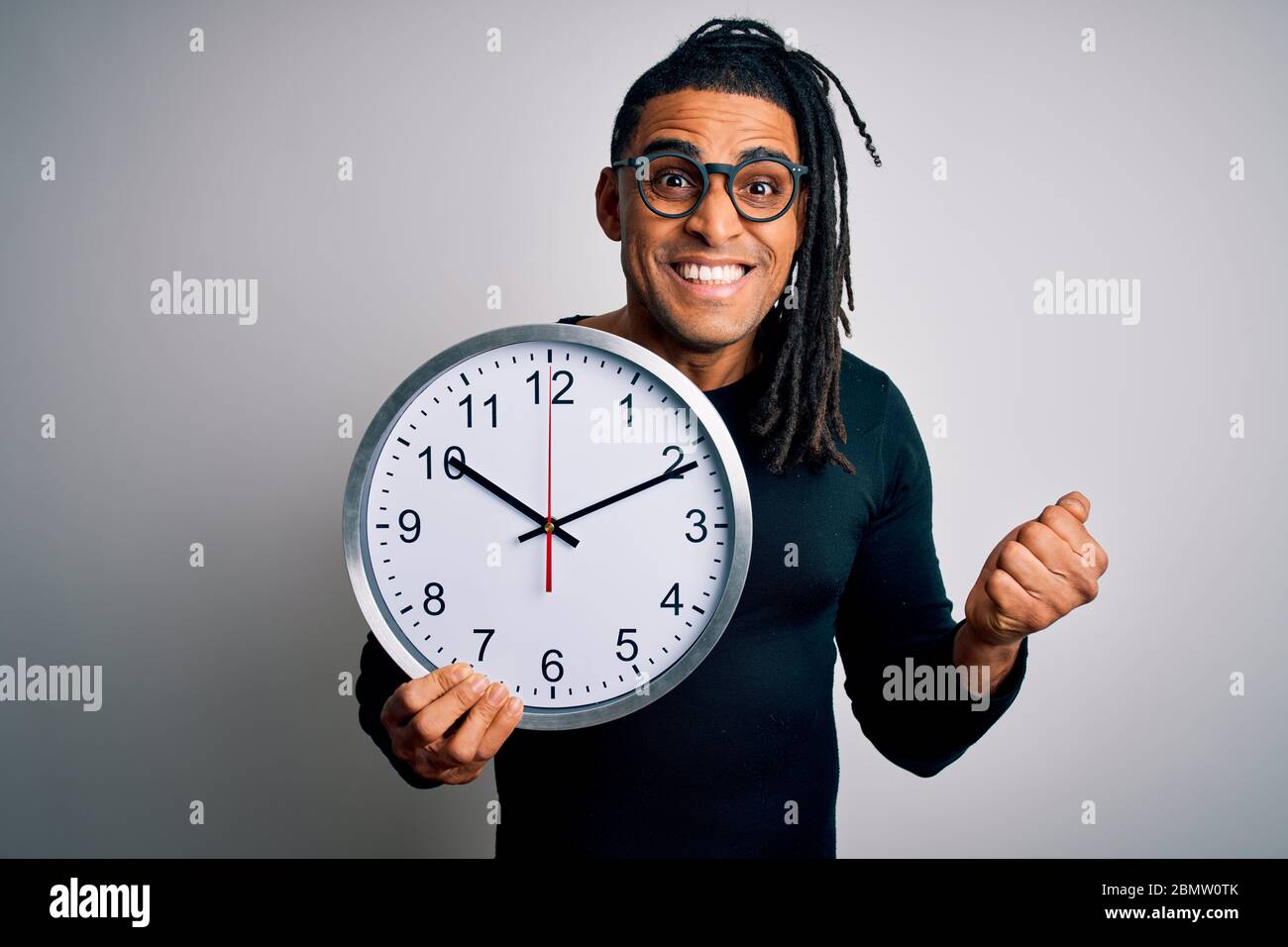 Young african american afro man doing countdown holding bic clock over ...