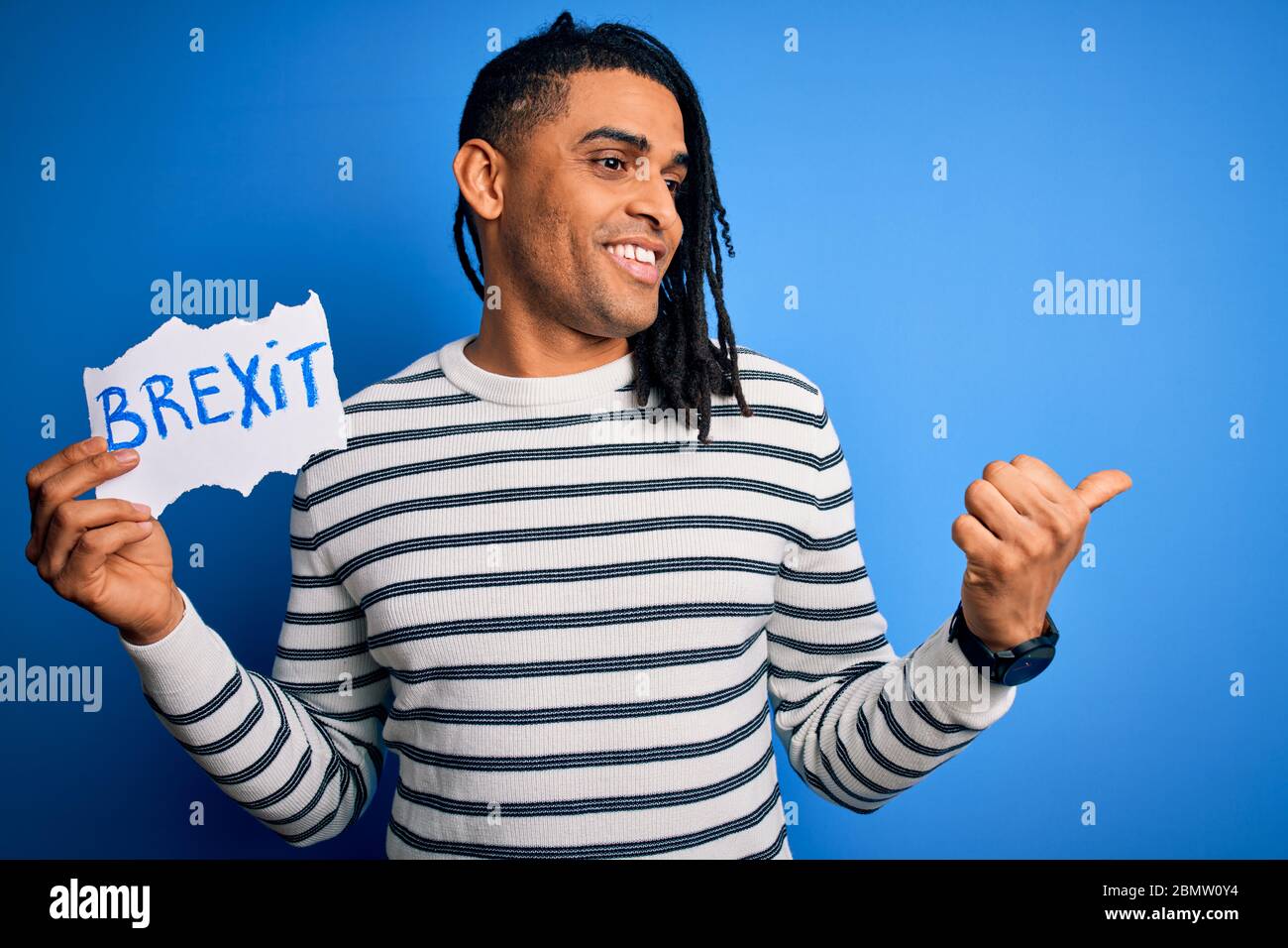 Young african american afro man holding banner with brexit message over ...