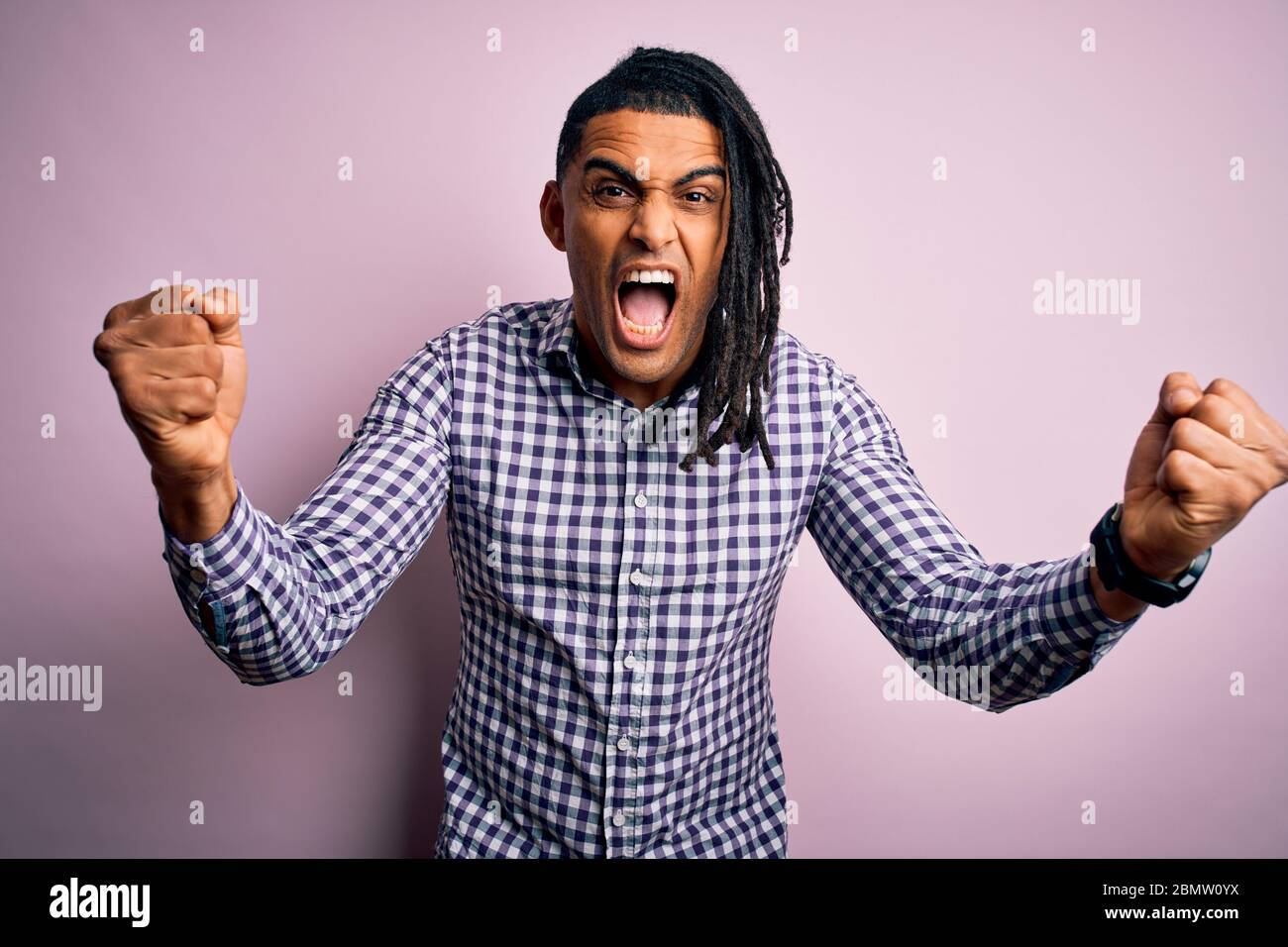 Young handsome african american afro man with dreadlocks wearing casual ...