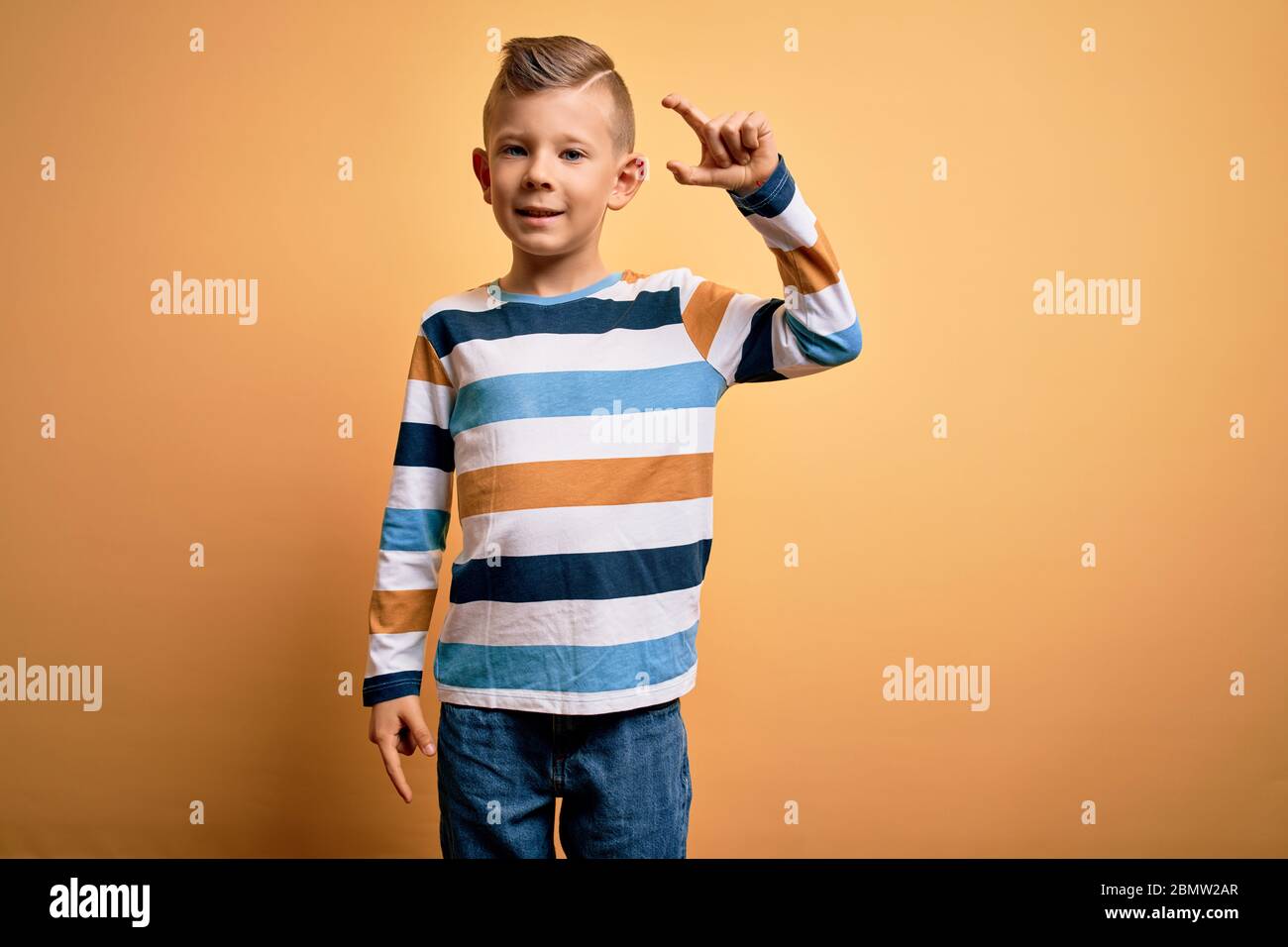 Young little caucasian kid with blue eyes wearing colorful striped ...
