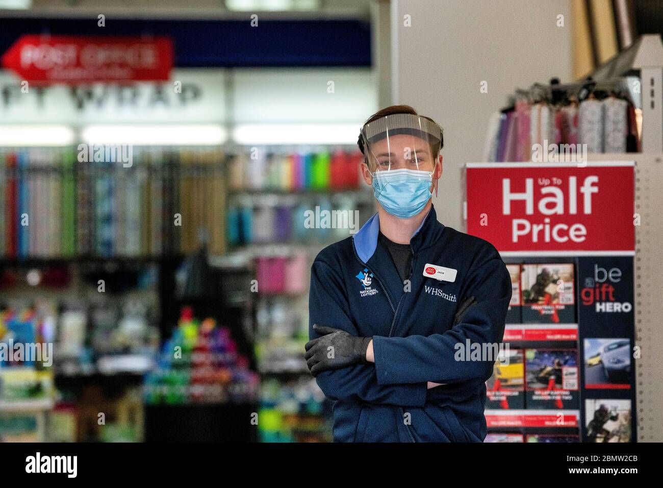 A WHSmith worker in PPE greets people at the store entrance in Bath ...