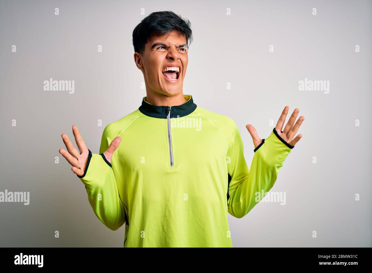 Young handsome sportsman doing sport wearing sportswear over isolated ...